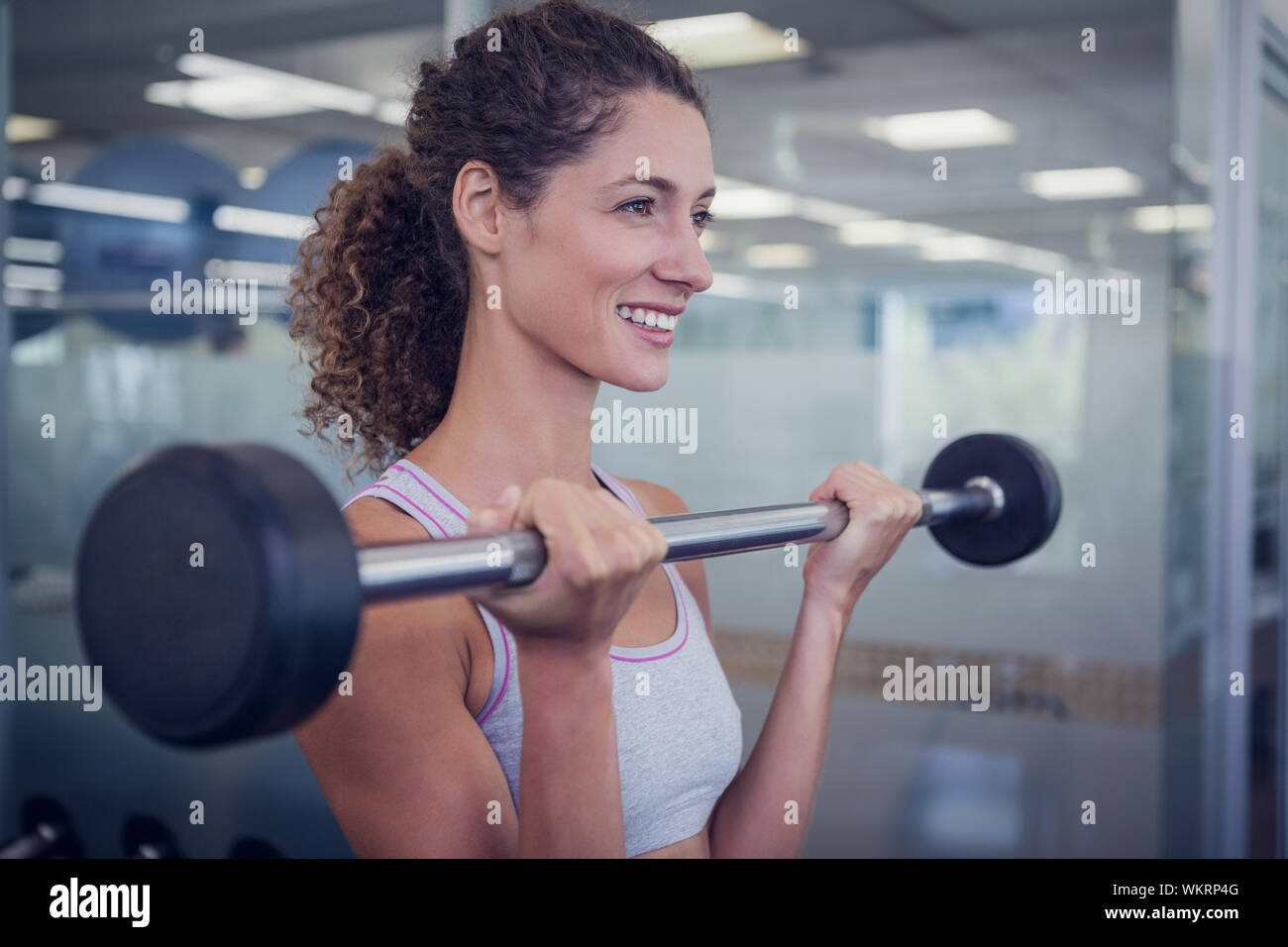 Pretty woman lifting barbell hi-res stock photography and images - Alamy
