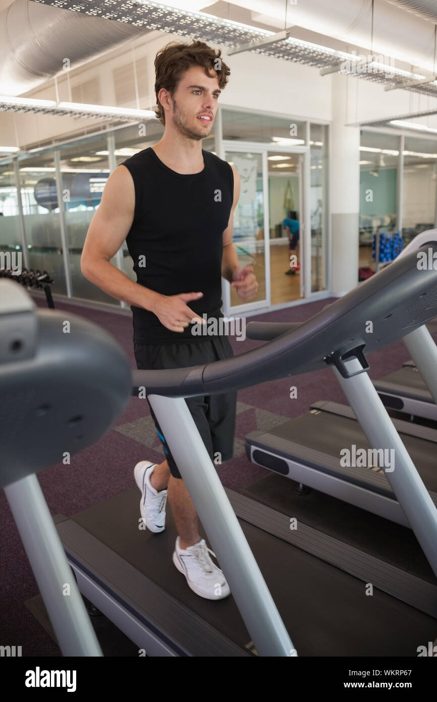 Fit man jogging on the treadmill at the gym Stock Photo - Alamy
