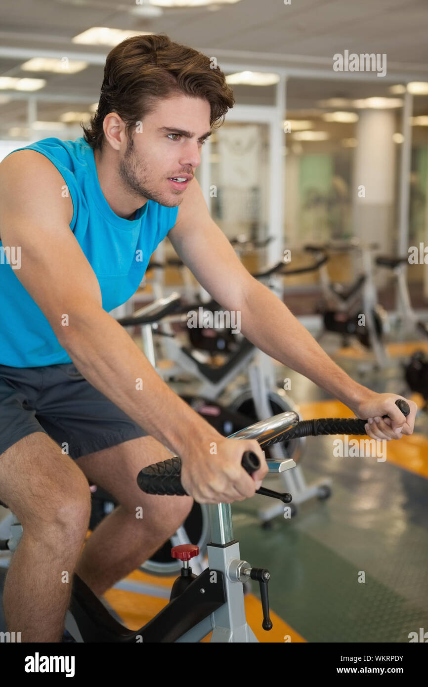 Focused fit man on the spin bike at the gym Stock Photo - Alamy