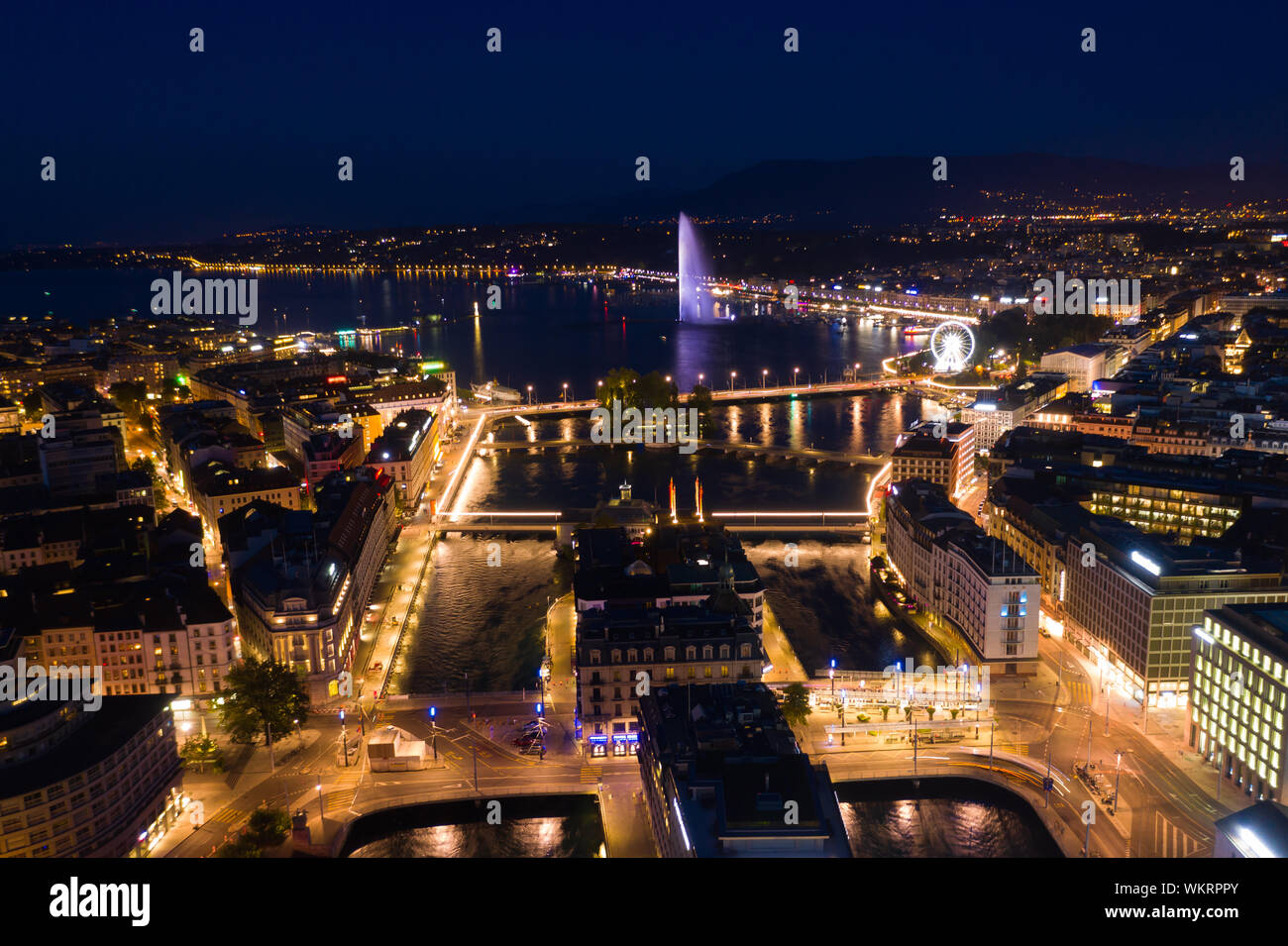 Aerial night view of Geneva city waterfront skyline in Switzerland ...