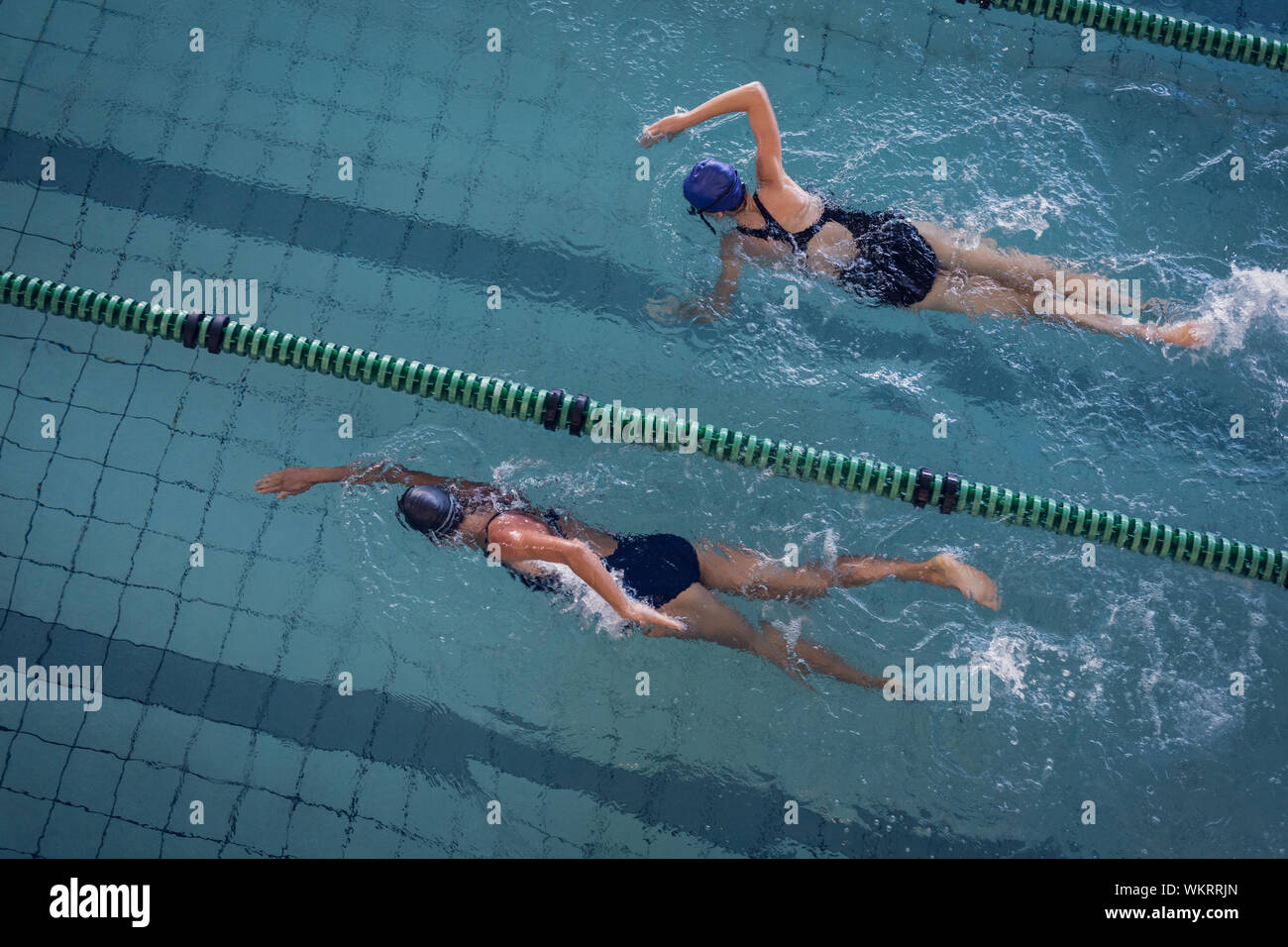 Female swimmers racing in the swimming pool at the leisure center Stock ...