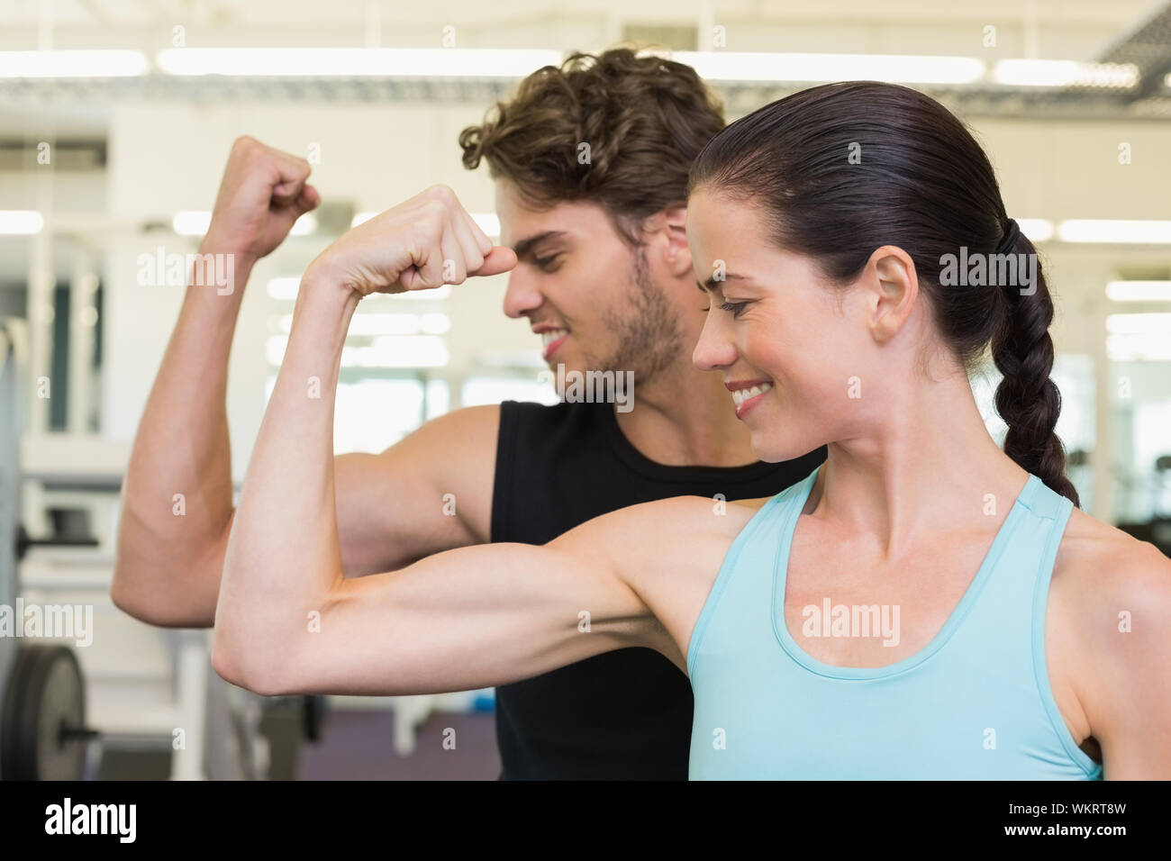 Muscular couple flexing biceps hi-res stock photography and images - Alamy