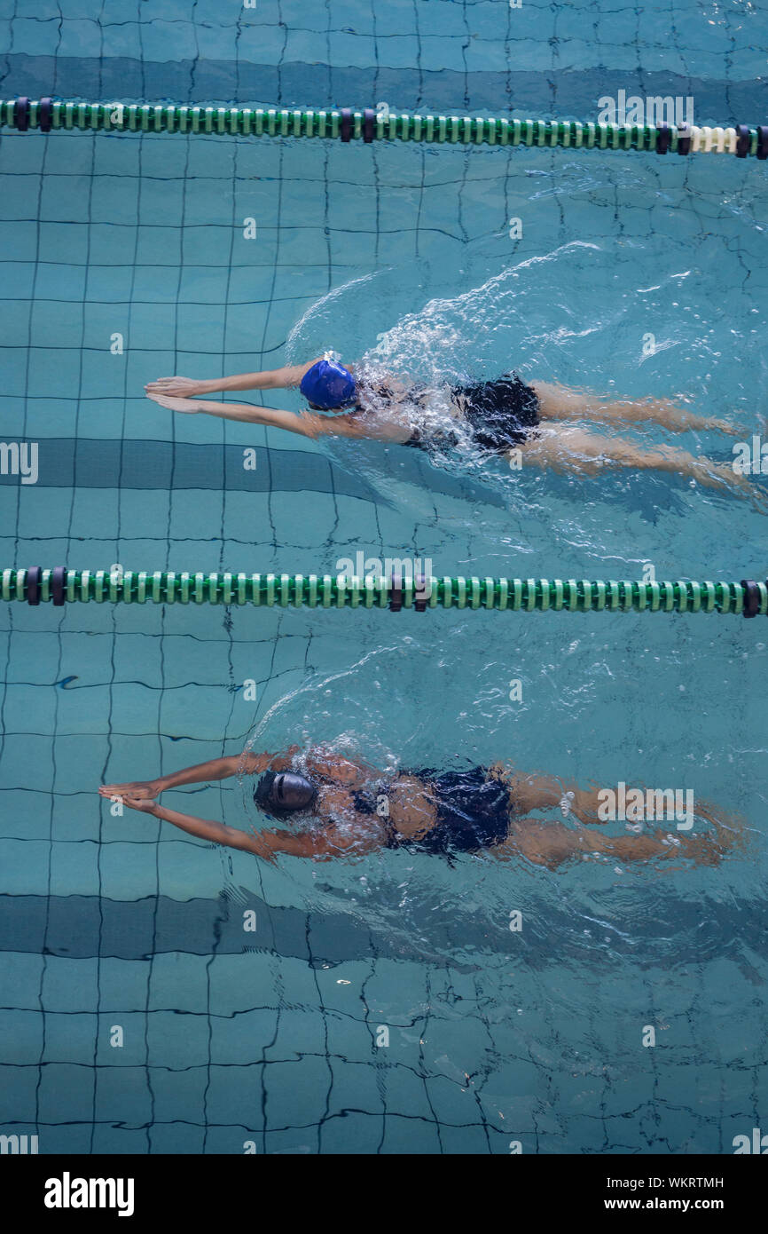 Female swimmers racing in the swimming pool at the leisure center Stock ...