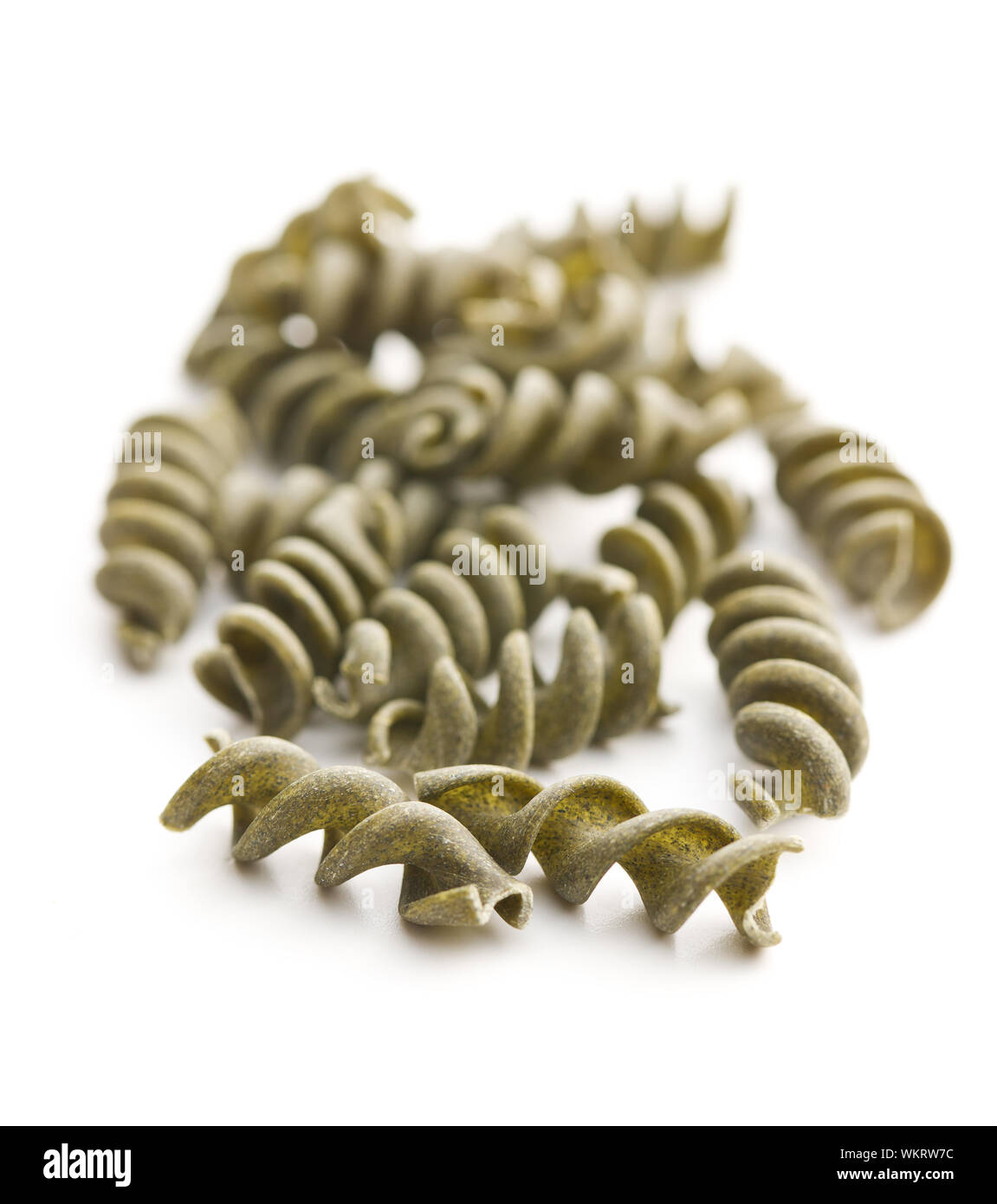 Uncooked colorful pasta with spinach flavor isolated on white ...