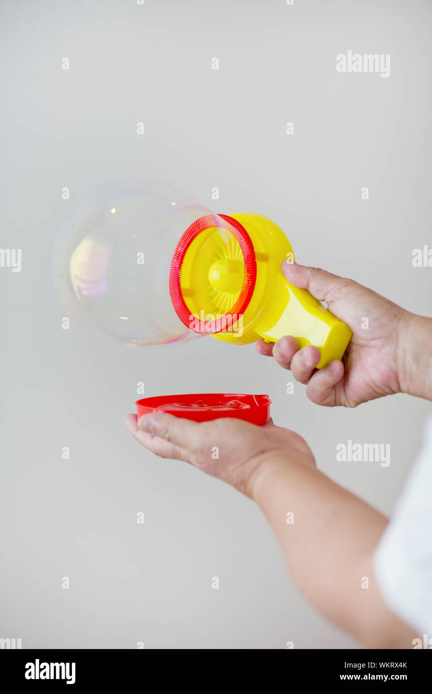 Hand holding bubble wand hi-res stock photography and images - Alamy