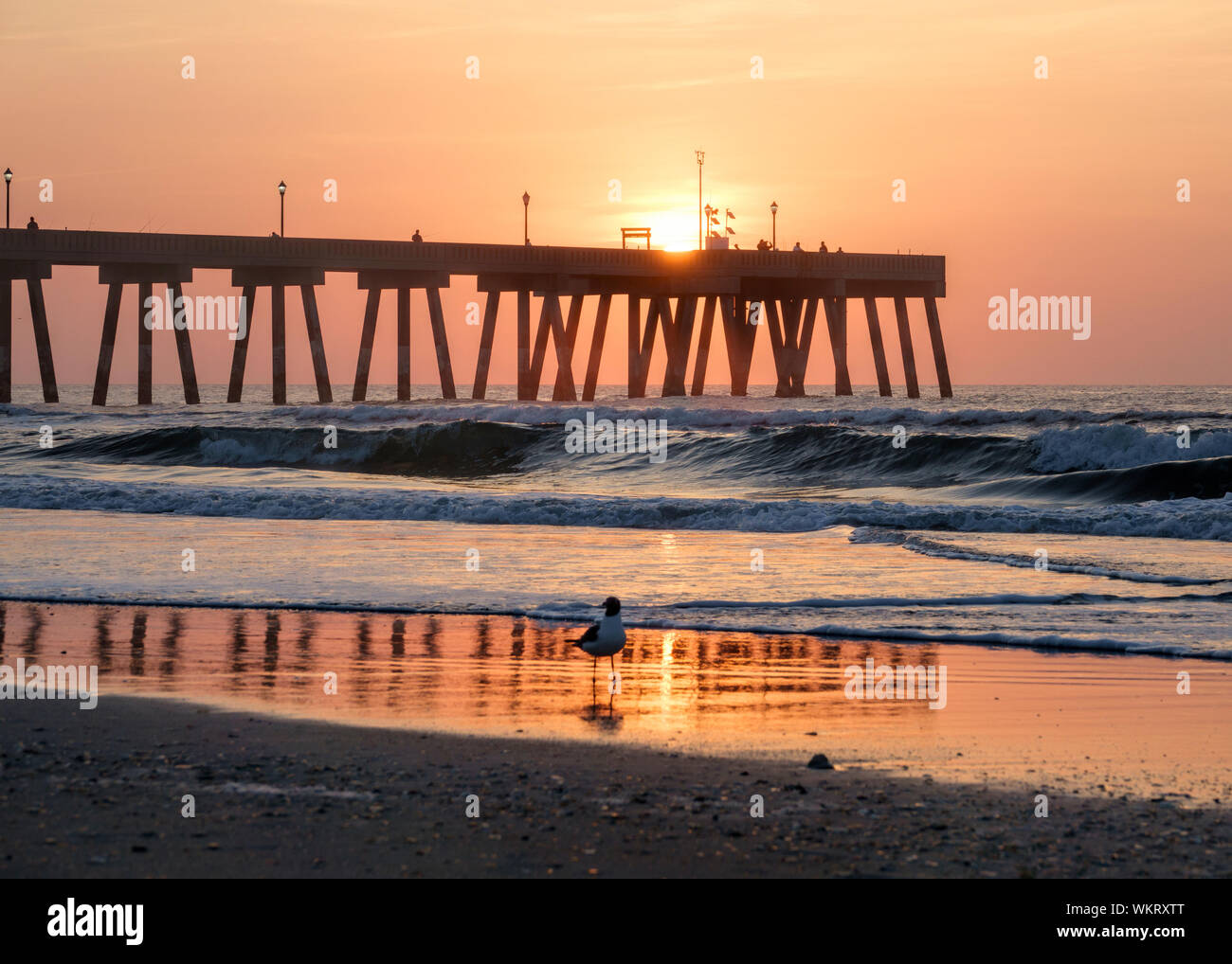 Pier on beach at sunset hi-res stock photography and images - Alamy