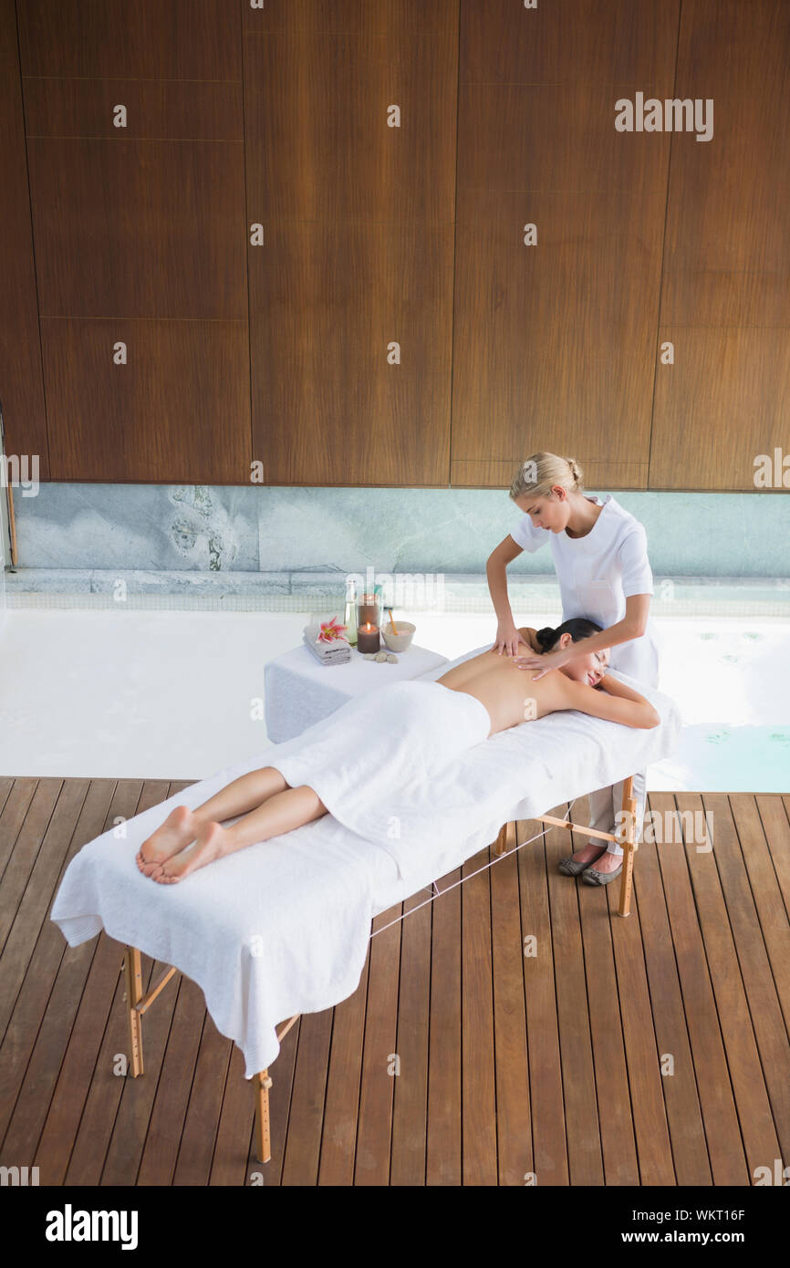 Brunette getting a back massage at the spa Stock Photo - Alamy