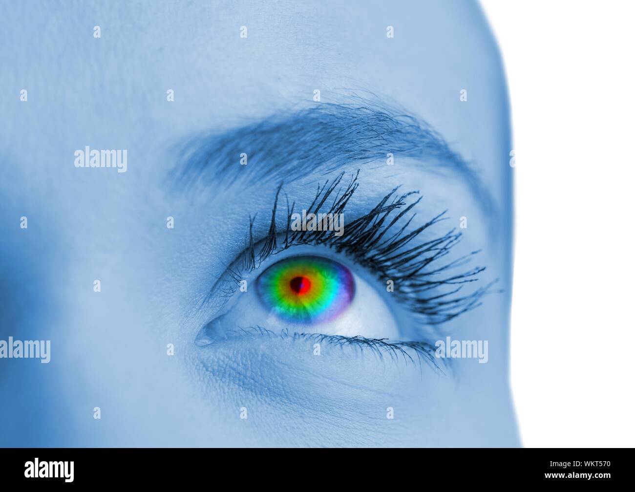 Psychedelic eye on blue face looking up Stock Photo - Alamy