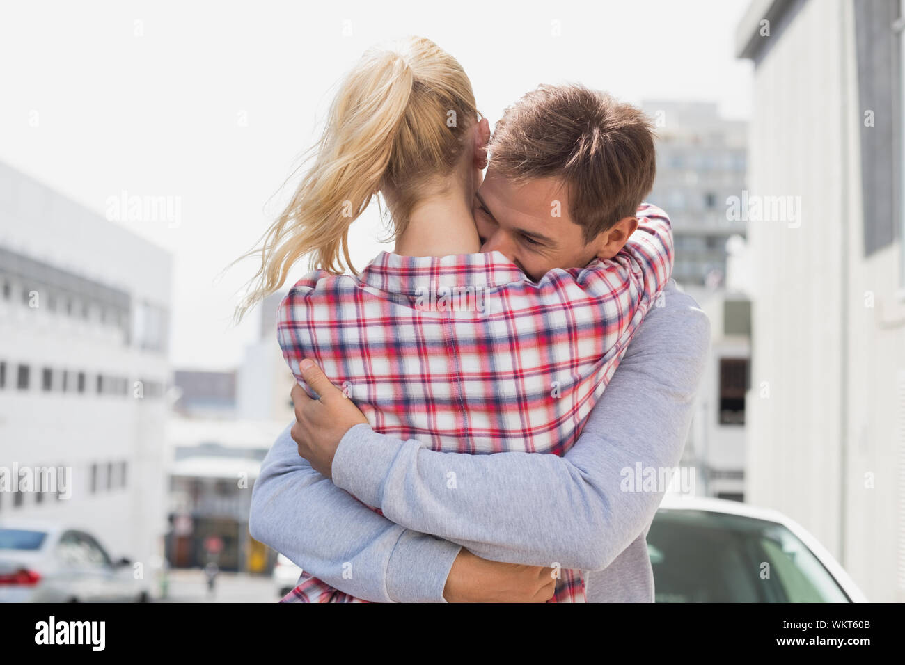 Hip young couple hugging each other on a sunny day in the city Stock ...