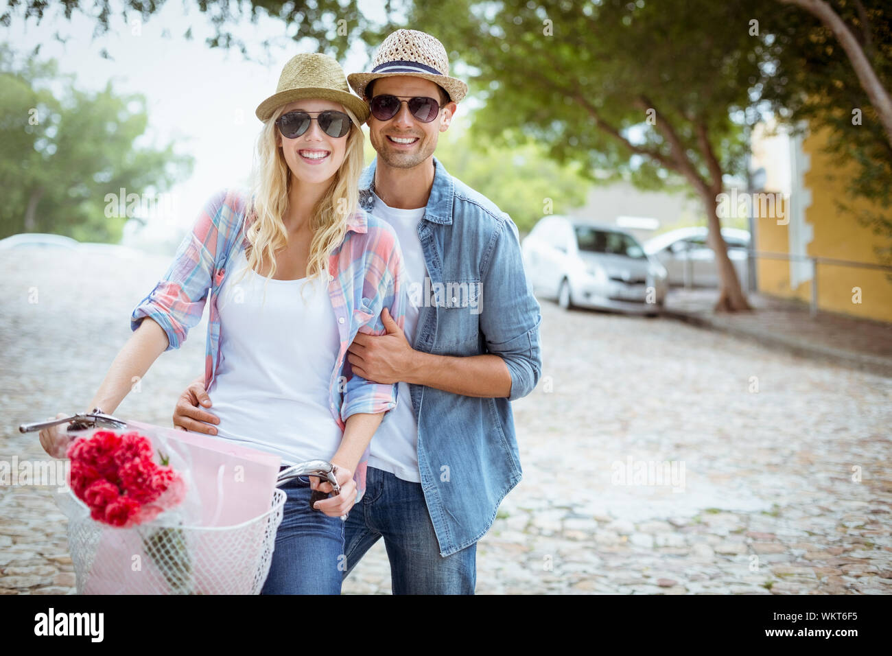 Hip young couple going for a bike ride on a sunny day in the city Stock ...