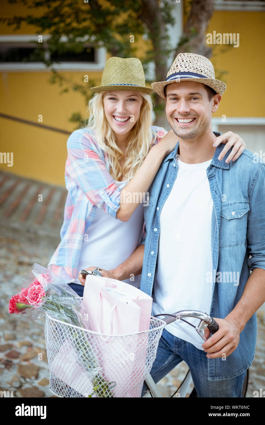 Hip young couple going for a bike ride on a sunny day in the city Stock ...