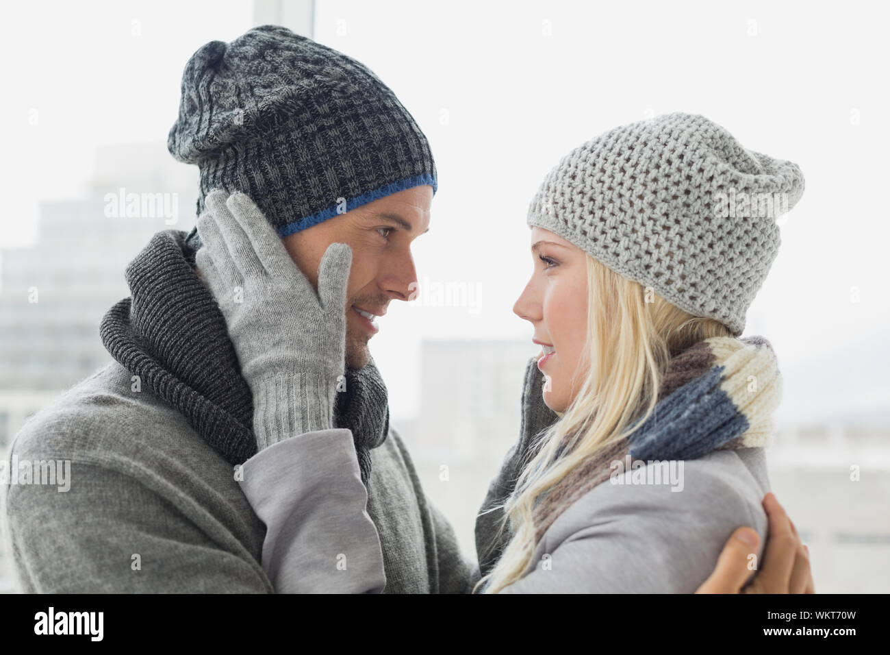 Cute couple in warm clothing hugging on a chilly day Stock Photo - Alamy