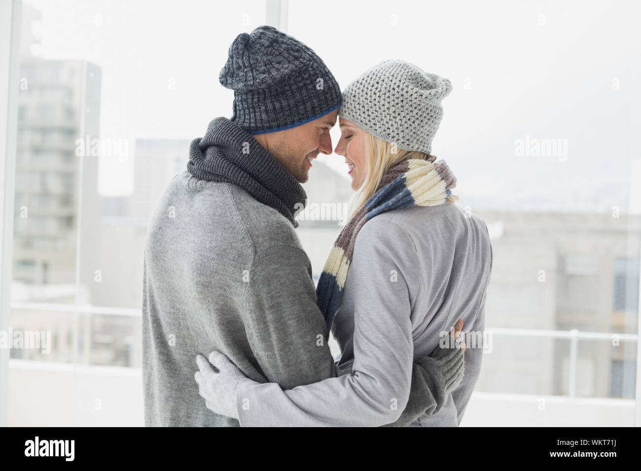 Cute couple in warm clothing hugging on a chilly day Stock Photo - Alamy
