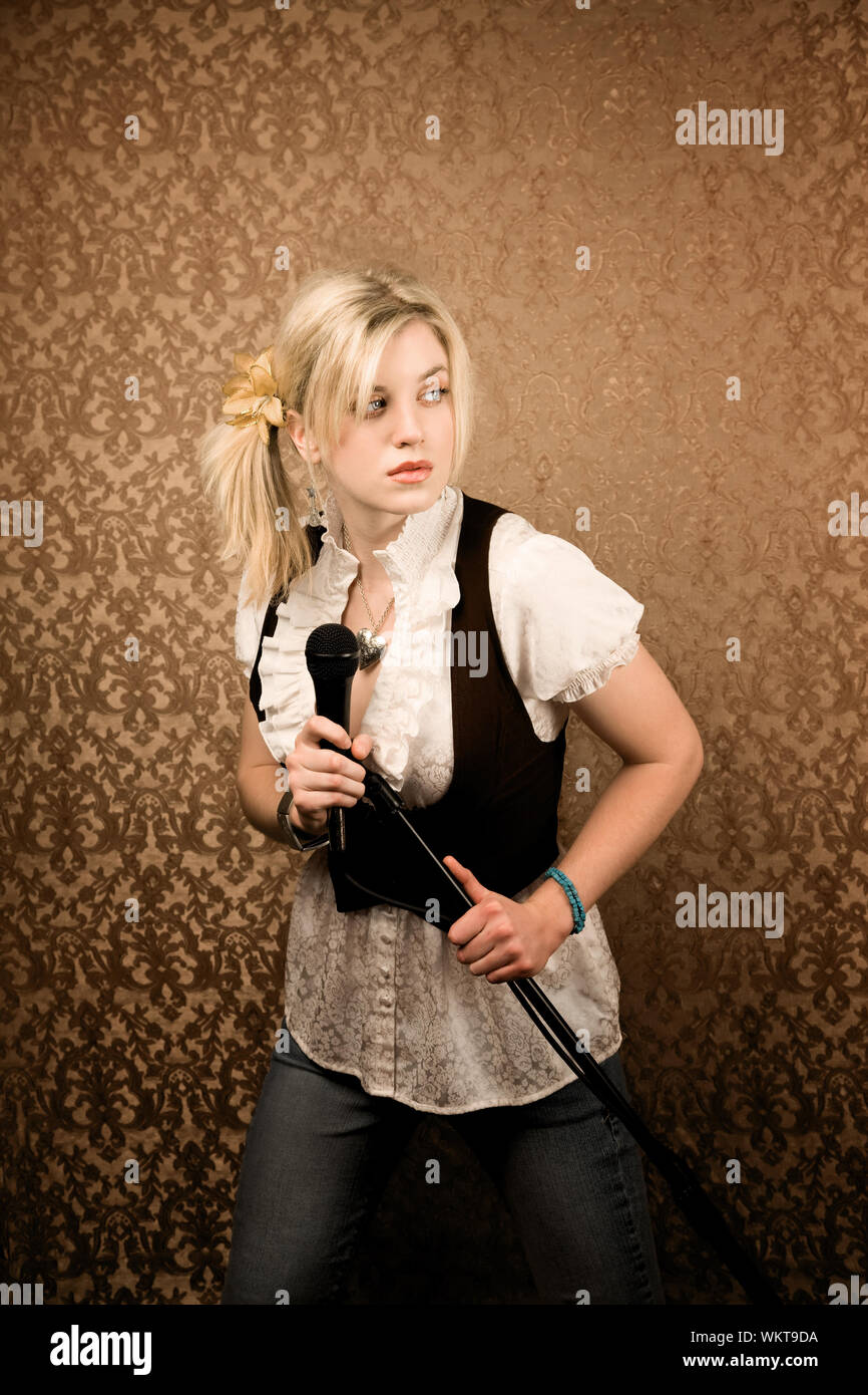 Pretty young singer or comedian with microphone and stand Stock Photo ...