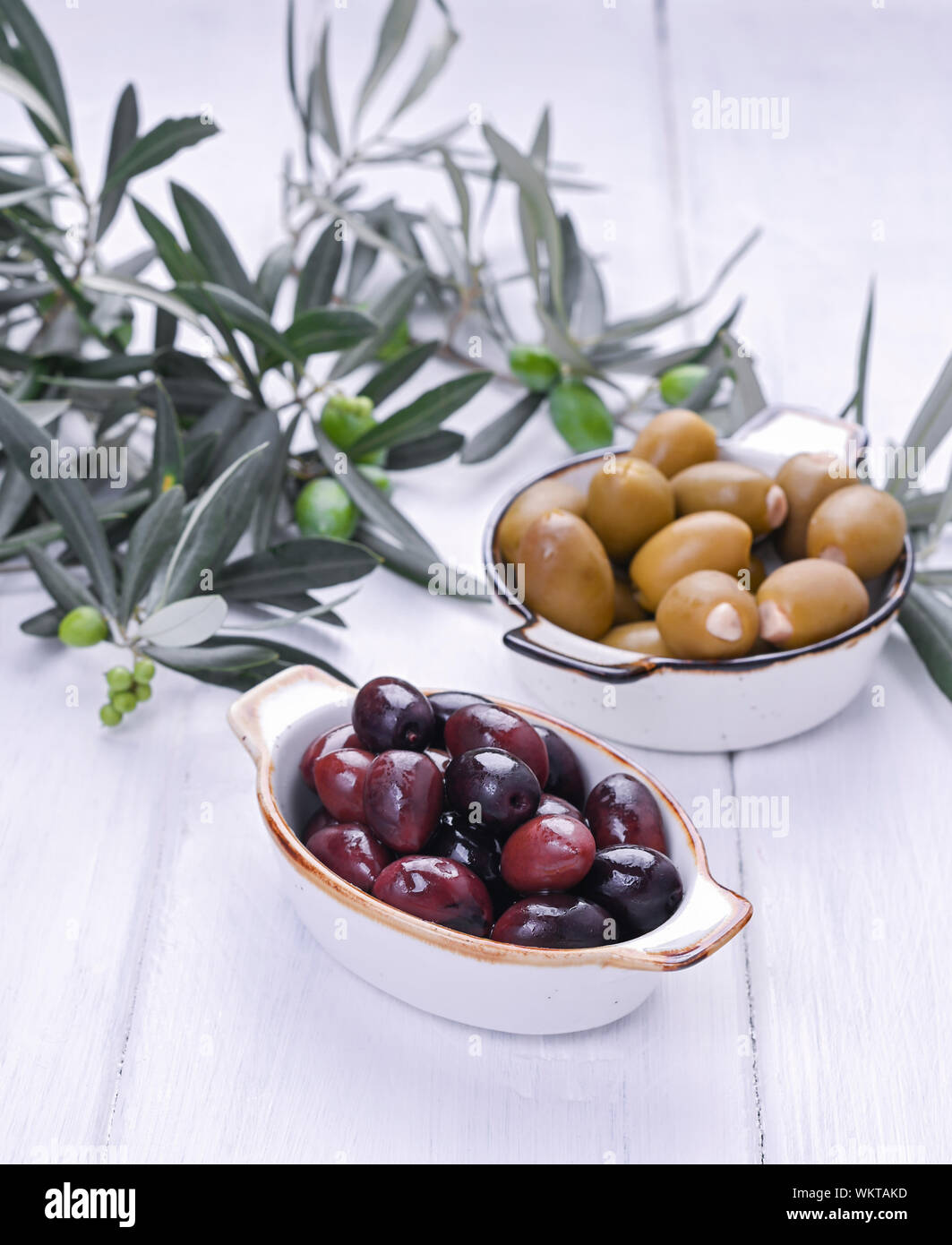 Traditional appetizers, green and red olives from Greek cuisine. White ...