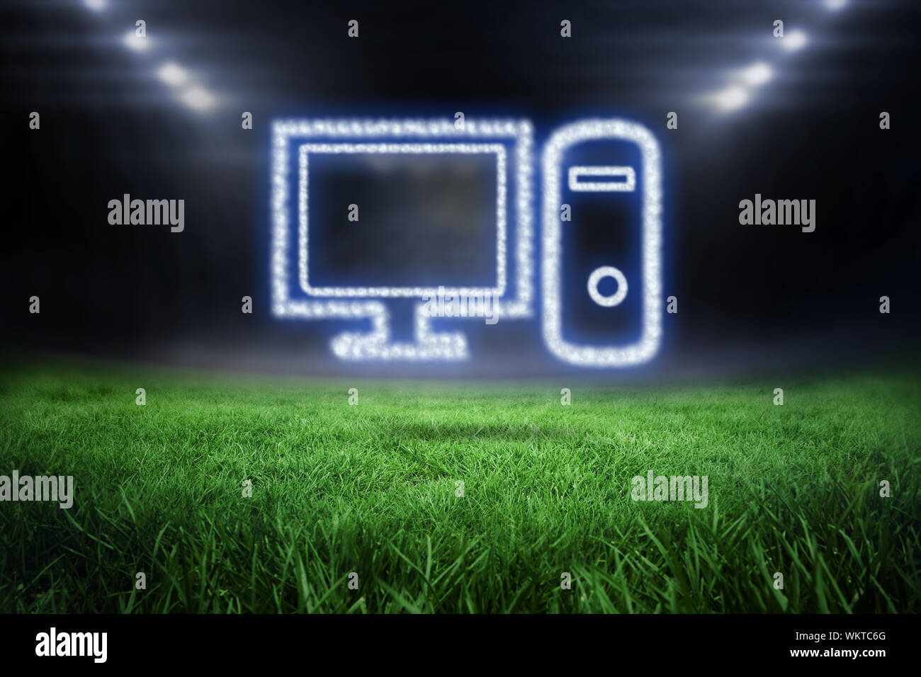 Cloud in shape of computer against football pitch with bright lights ...