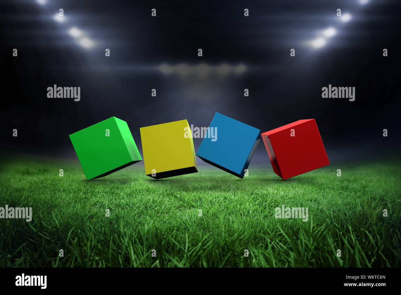 3d colourful cubes in a row against football pitch with bright lights ...
