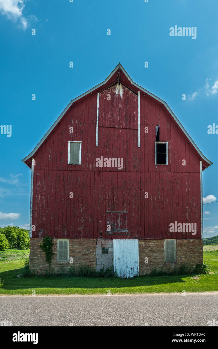 A large red barn front facing closeup view in rural midwest on a bright ...
