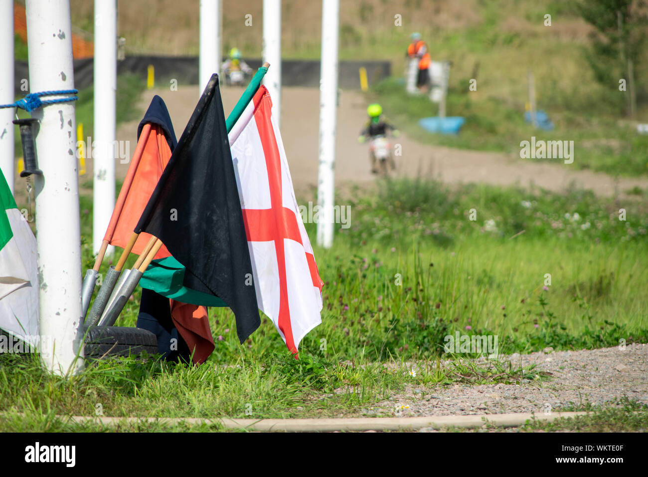 Focus on flags in different colors at motocross race track with ...