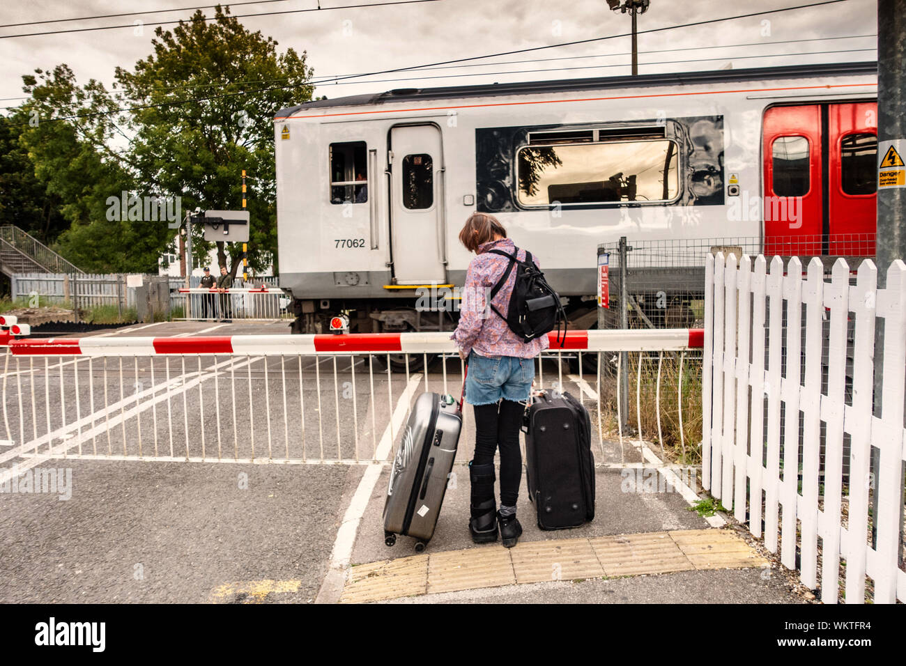 young girls waiting at train road crossing Stock Photo - Alamy