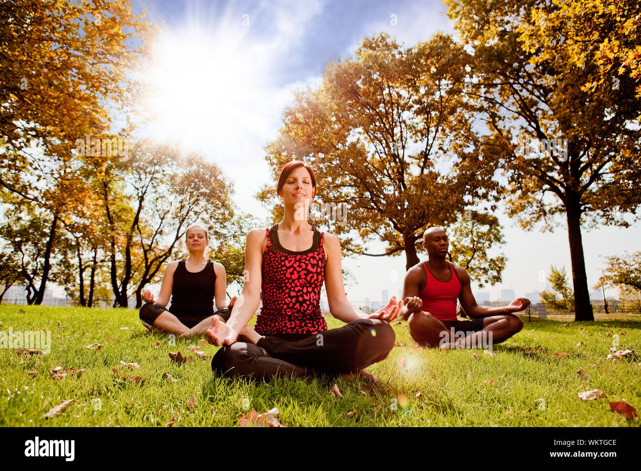 A group of people meditation in a city park in the morning - taken into ...