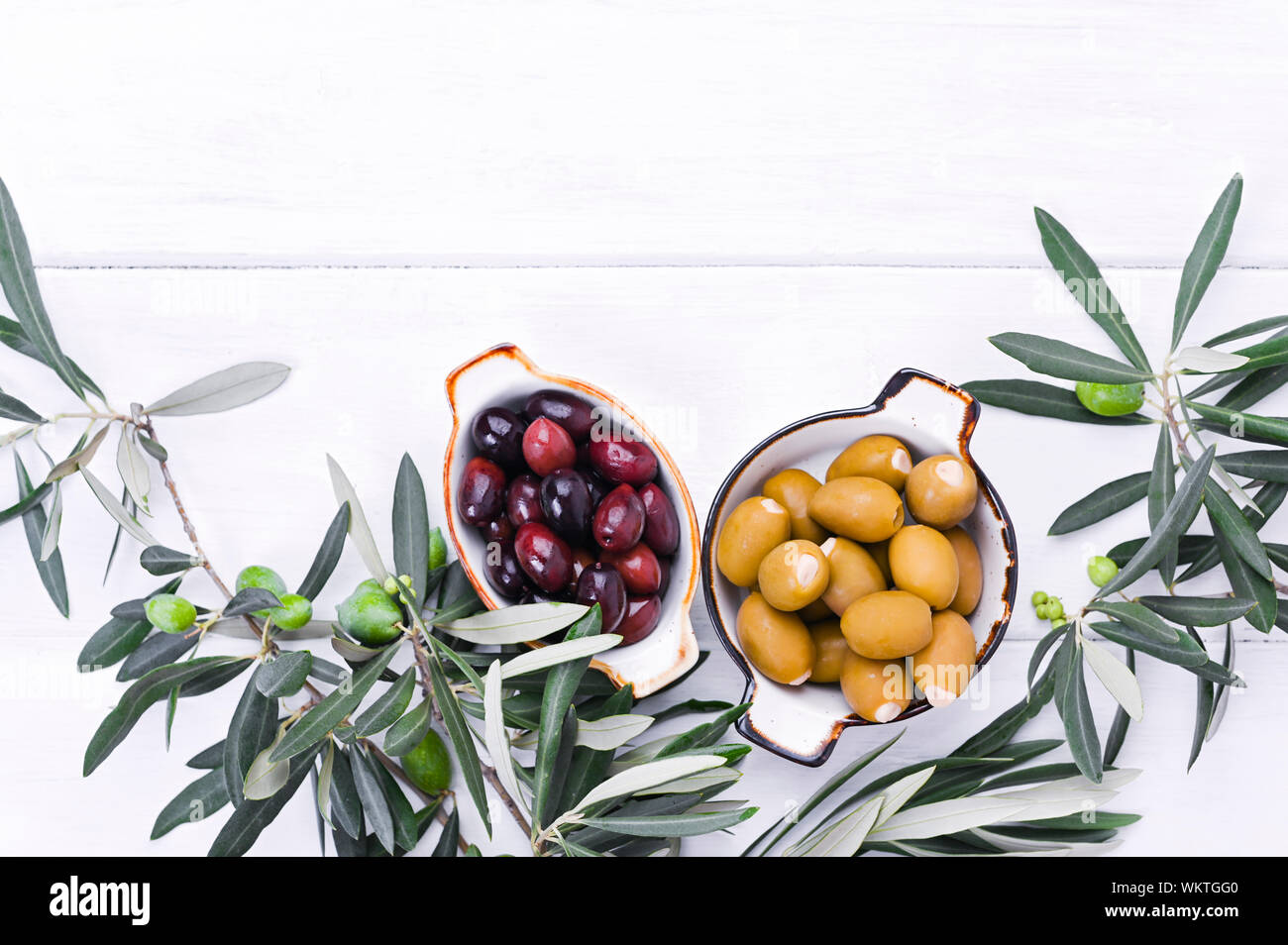 Traditional appetizers, green and red olives from Greek cuisine. White ...