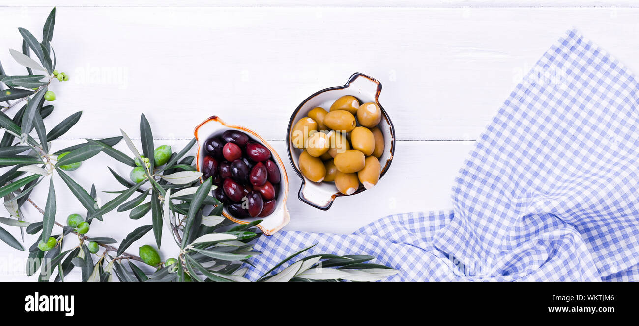 Traditional appetizers, green and red olives from Greek cuisine. White ...