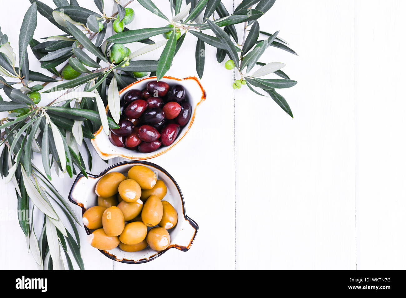 Traditional appetizers, green and red olives from Greek cuisine. White ...