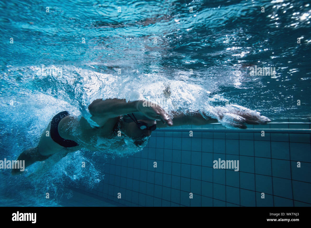 Fit swimmer training by himself in the swimming pool at the leisure ...