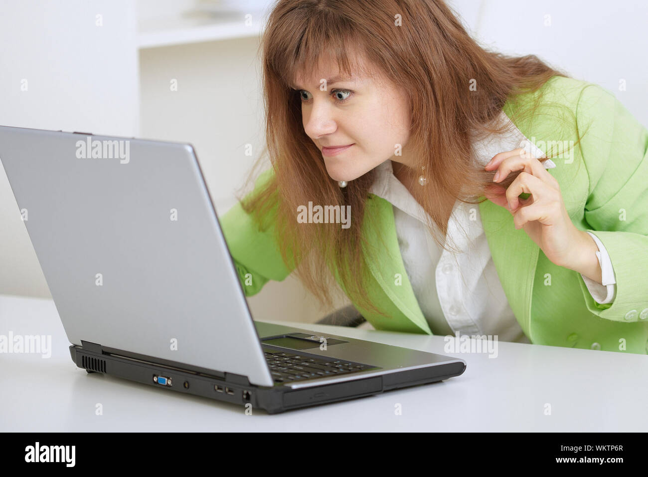 The girl is angry with the laptop and the Internet Stock Photo - Alamy