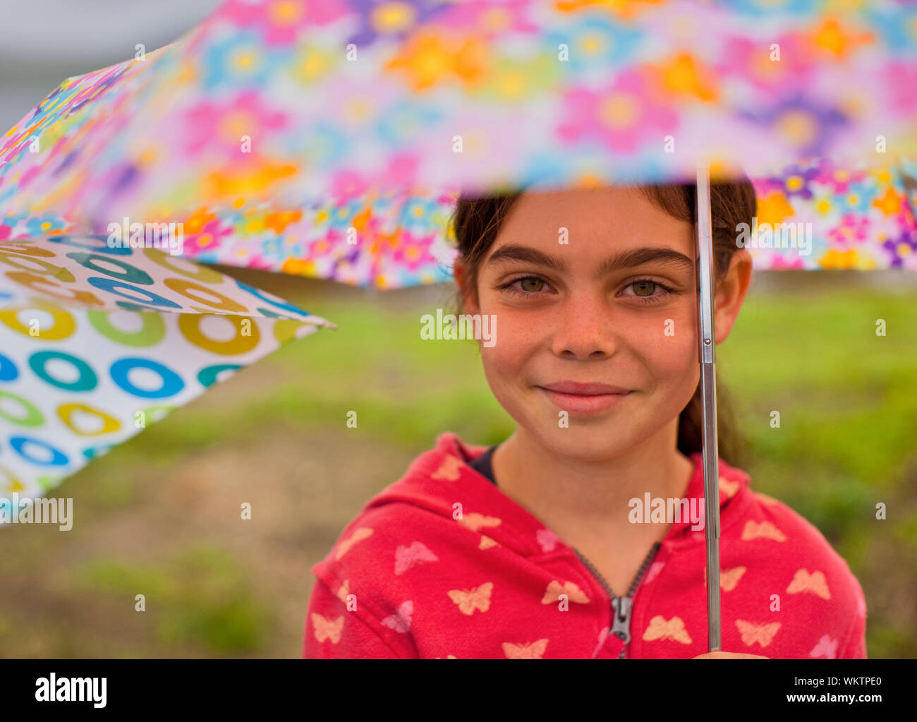 Happy girl holding remote hi-res stock photography and images - Alamy