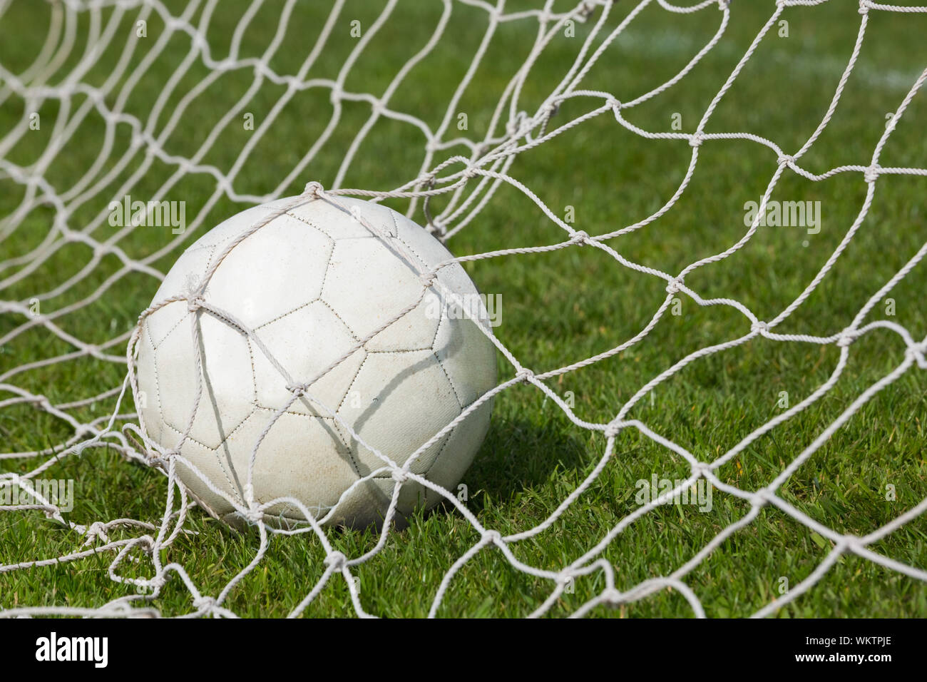 Football at the back of the net on a clear day Stock Photo - Alamy