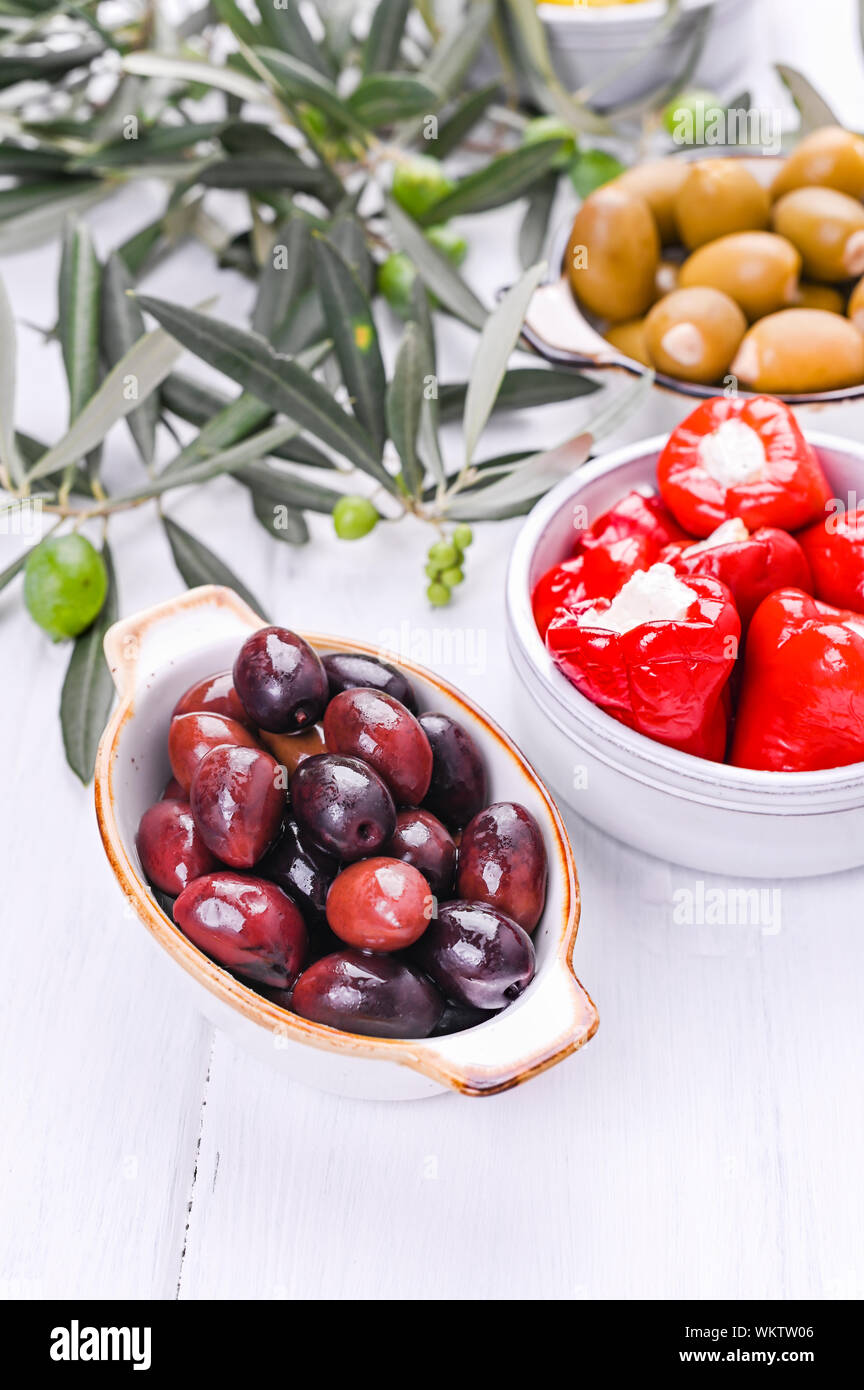 Traditional appetizers, olives from Greek cuisine. White wood ...