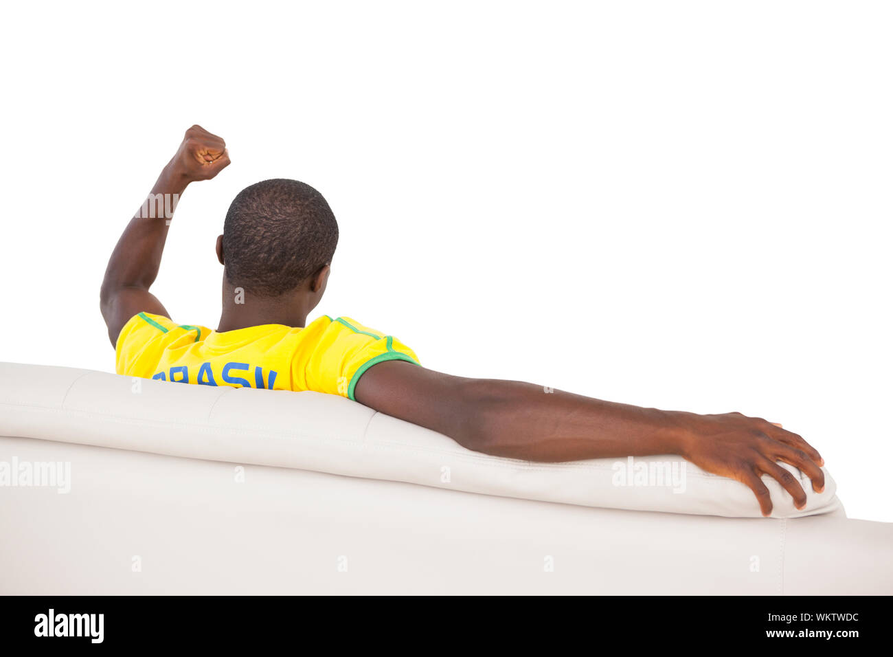 Man sitting on sofa and cheering on white background Stock Photo - Alamy