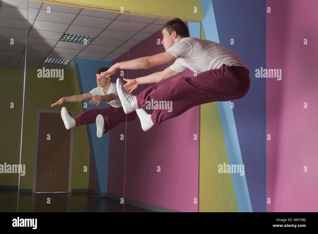 Cool break dancer mid air doing the splits in front of mirror in the ...