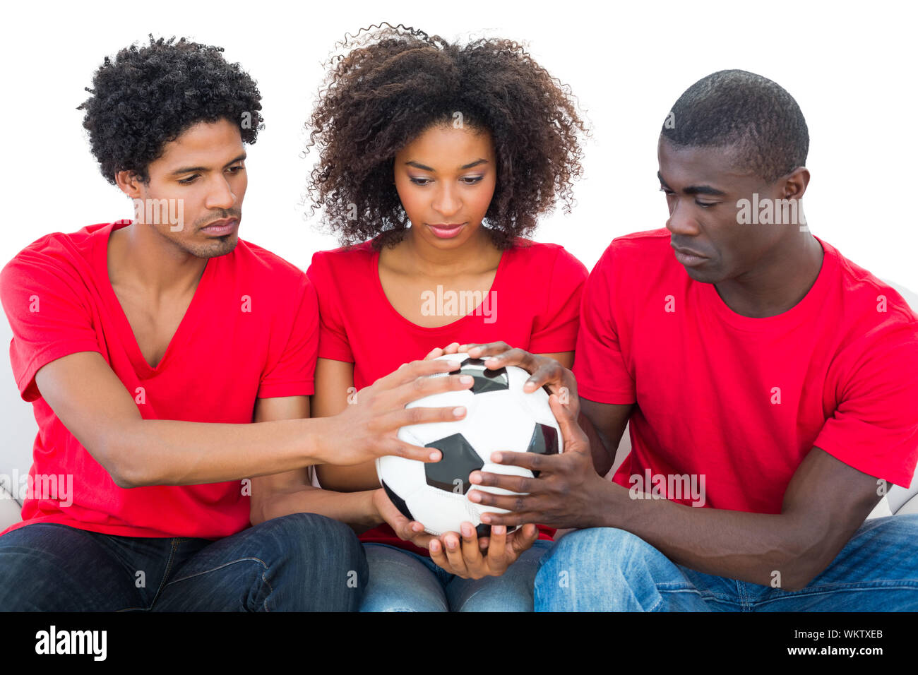 Football fans in red holding ball together on white background Stock ...