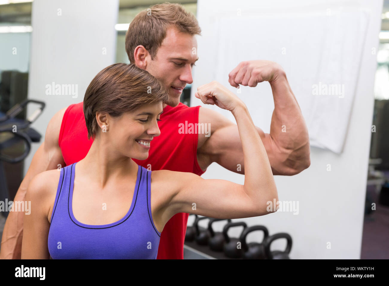 Muscular couple flexing biceps hi-res stock photography and images - Alamy