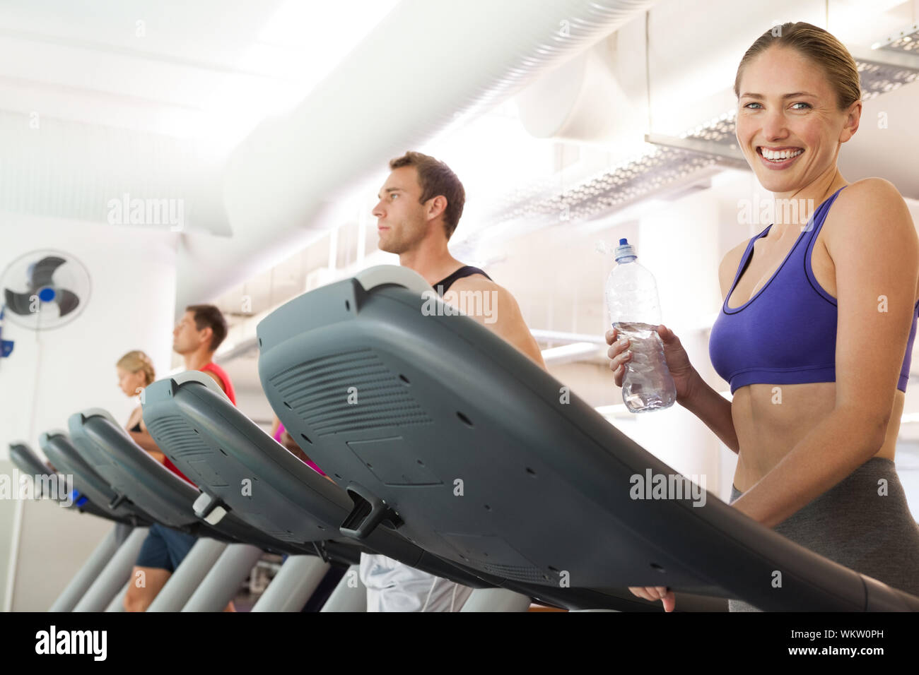 Female exercising on treadmill holding hi-res stock photography and ...