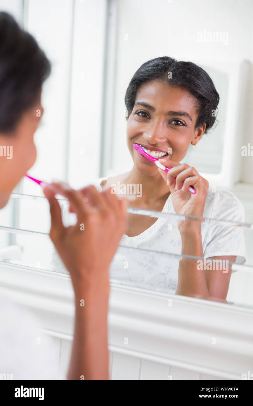 Pretty woman brushing her teeth at home in bathroom Stock Photo - Alamy