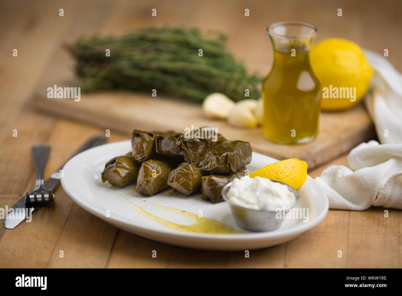 greek appetizers with olives and dips served on white plates with pita ...