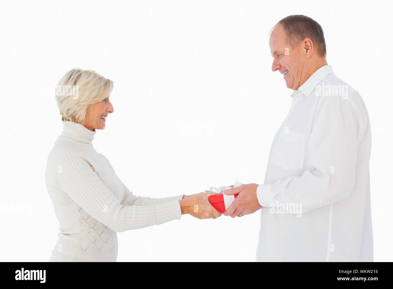 Blonde woman passing gift to her partner on white background Stock ...