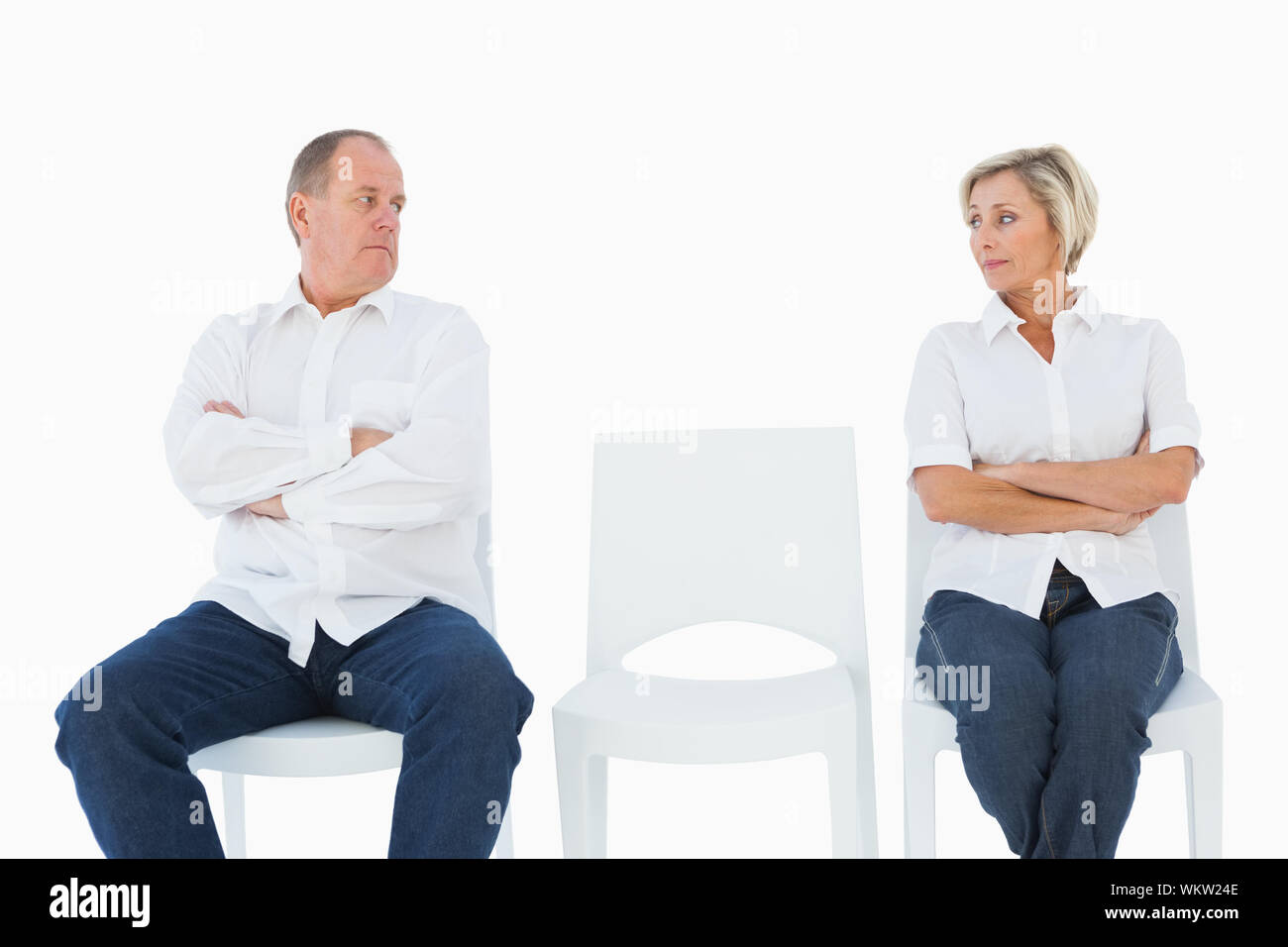Upset couple not talking to each other after fight on white background ...
