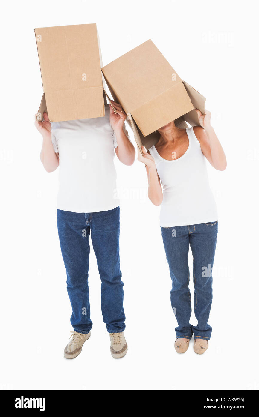 Mature couple wearing boxes over their heads on white background Stock ...