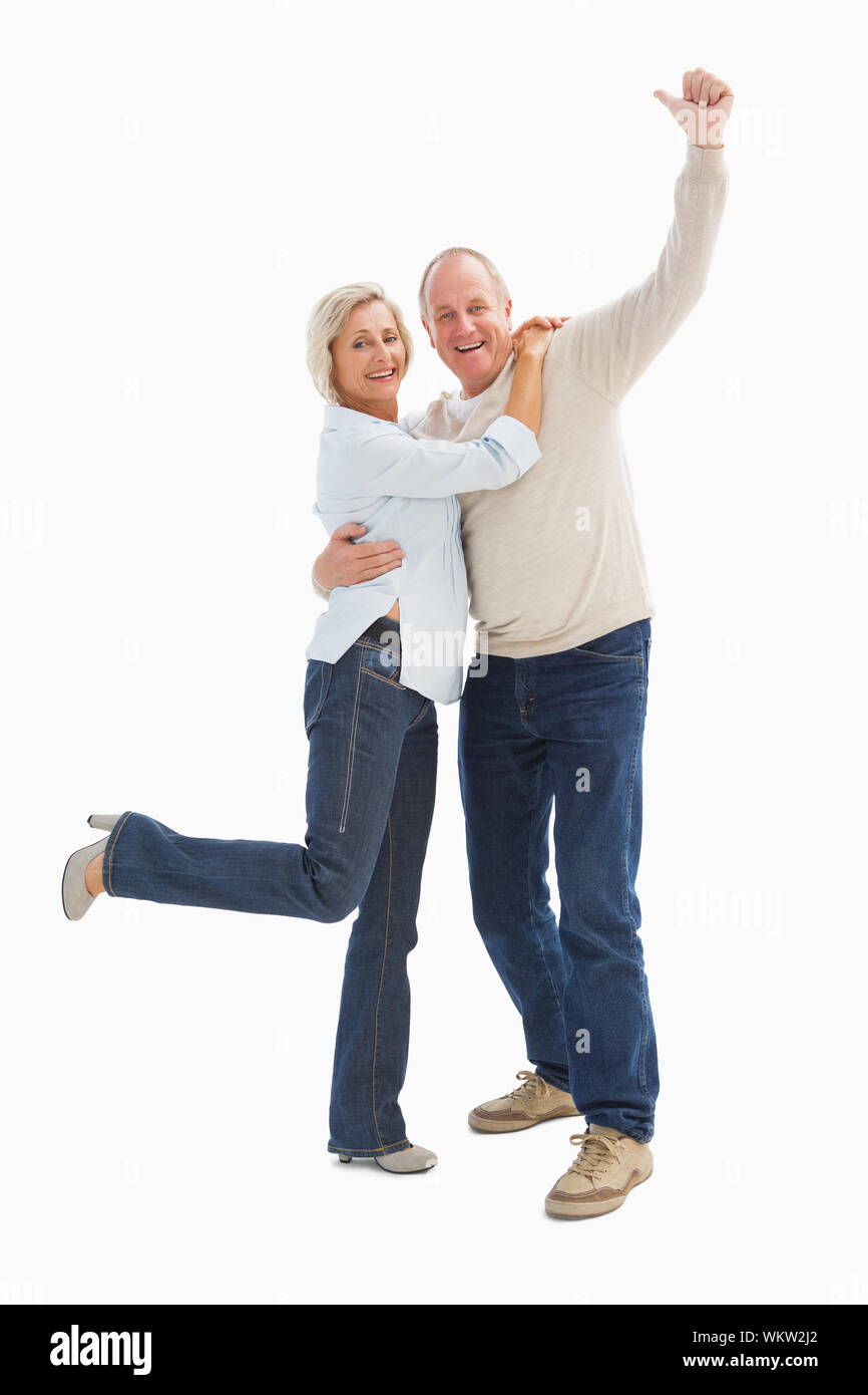 Happy mature couple cheering at camera on white background Stock Photo ...