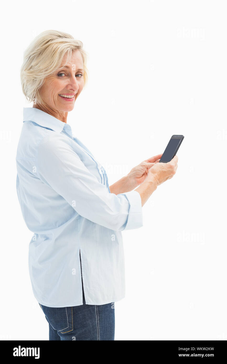 Happy mature woman sending a text on white background Stock Photo - Alamy