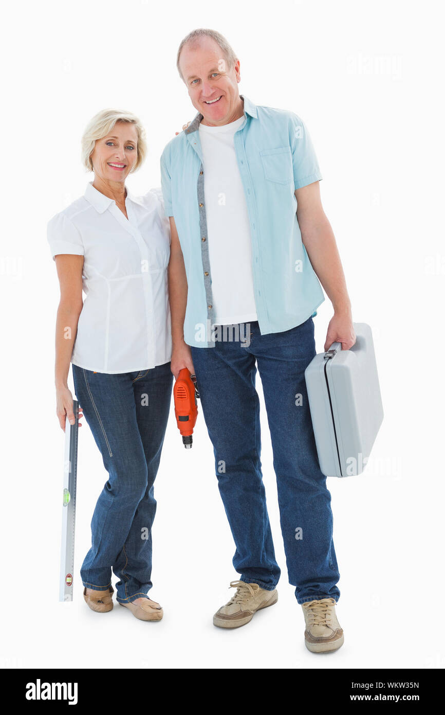Happy older couple holding diy tools on white background Stock Photo ...