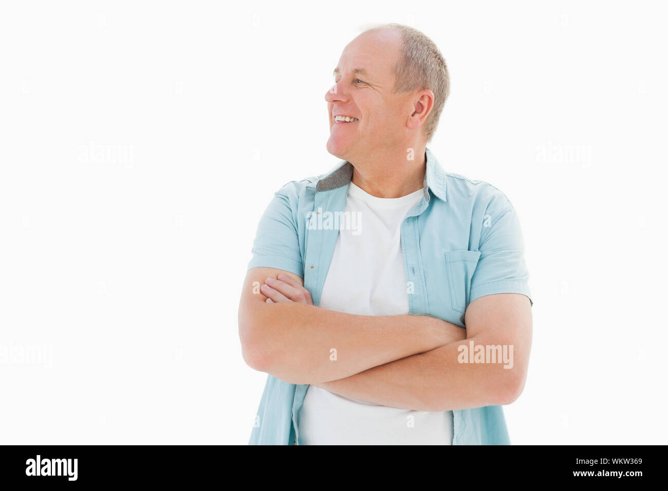 Happy older man with arms crossed on white background Stock Photo - Alamy
