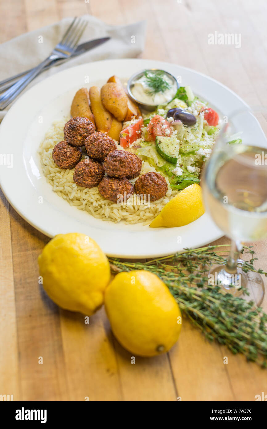 traditional Greek Dinner with rice, spices, salad on white dinner plate ...
