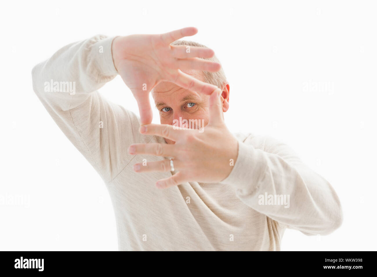 Happy mature man framing with hands on white background Stock Photo - Alamy