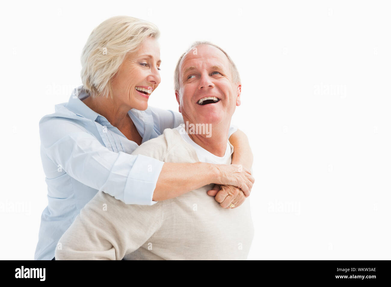 Happy mature couple smiling at each other on white background Stock ...